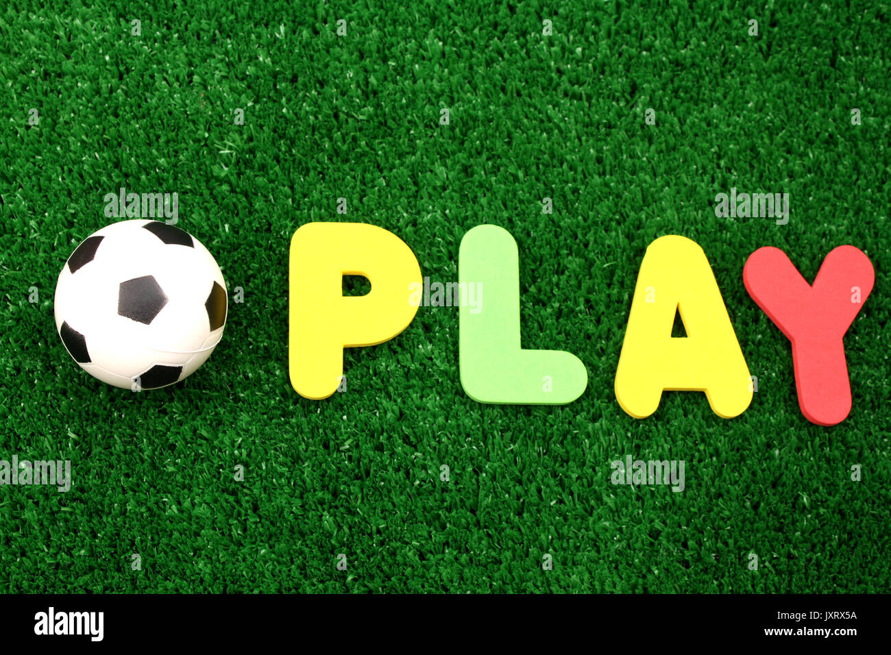 Play ball on atificial turf - word plastic colours Stock Photo - Alamy