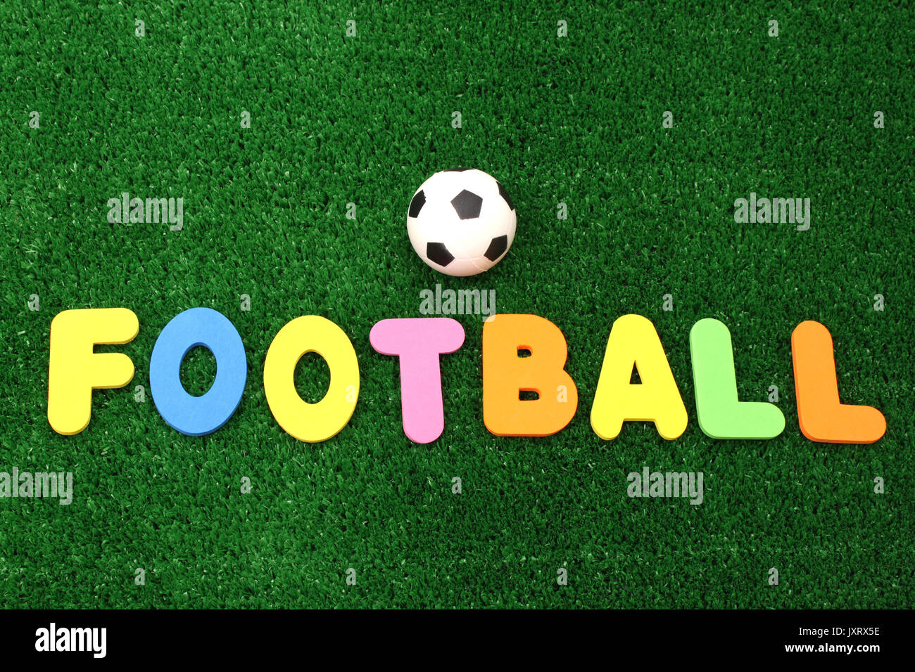 Football on atificial turf - word plastic colours Stock Photo - Alamy