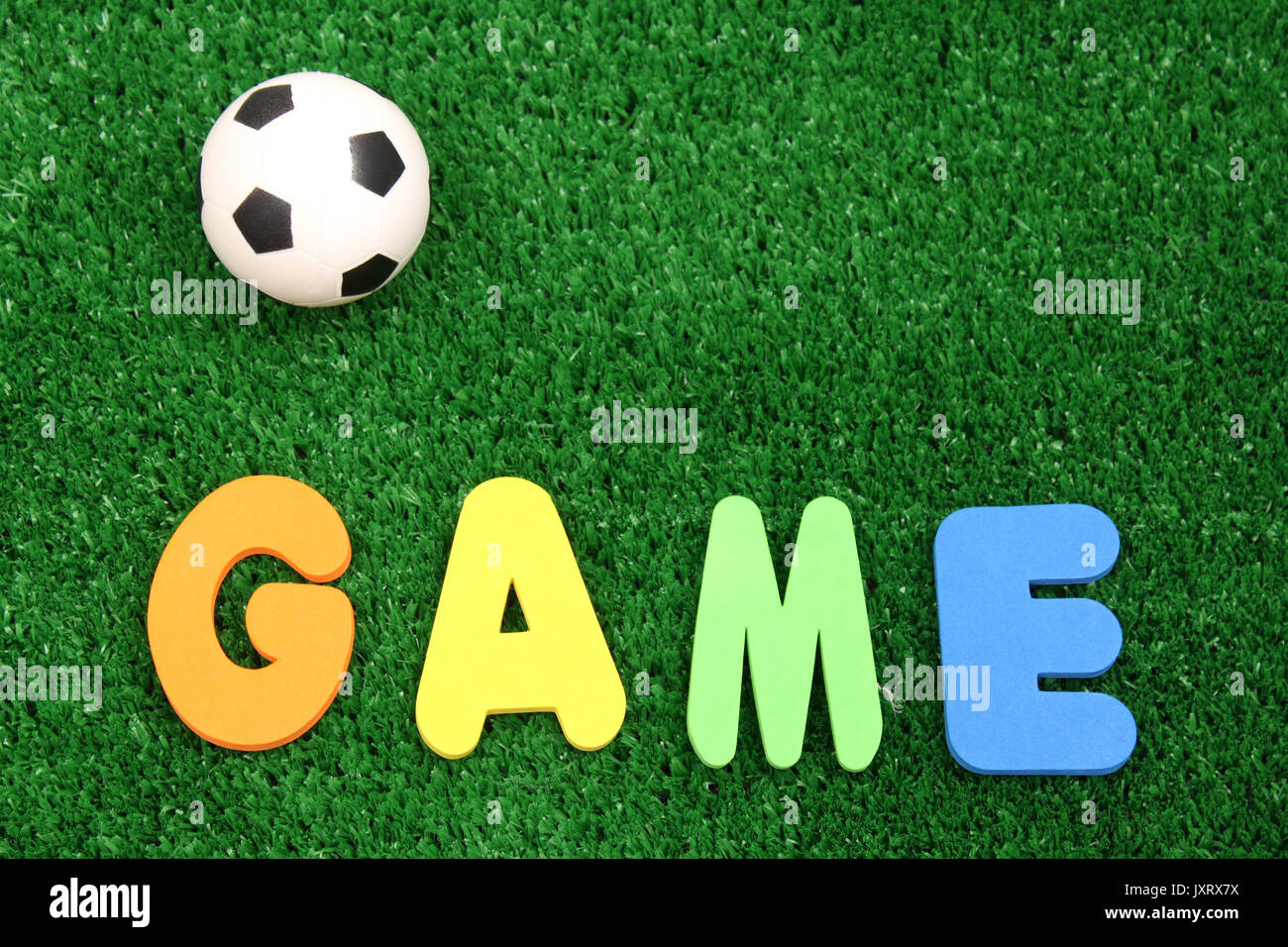 Game ball on atificial turf - word plastic colours Stock Photo - Alamy