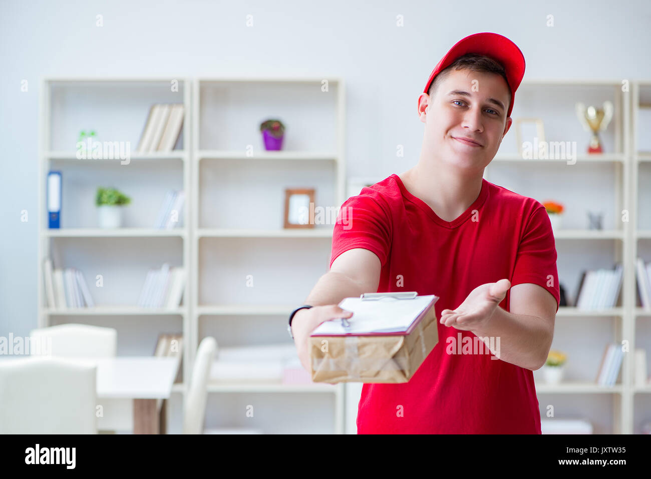 Post man delivering a parcel package Stock Photo - Alamy