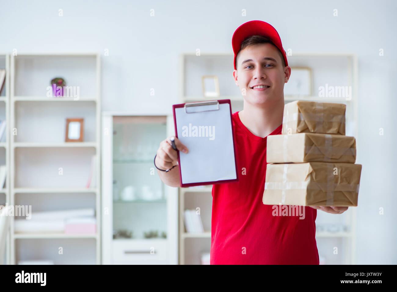 Post man delivering a parcel package Stock Photo - Alamy