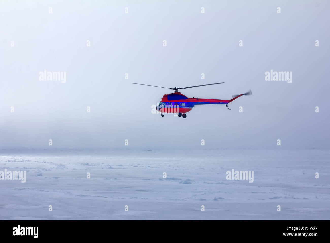 Near the North pole. Ship's helicopter in fog at Arctic ocean (pack ice ...