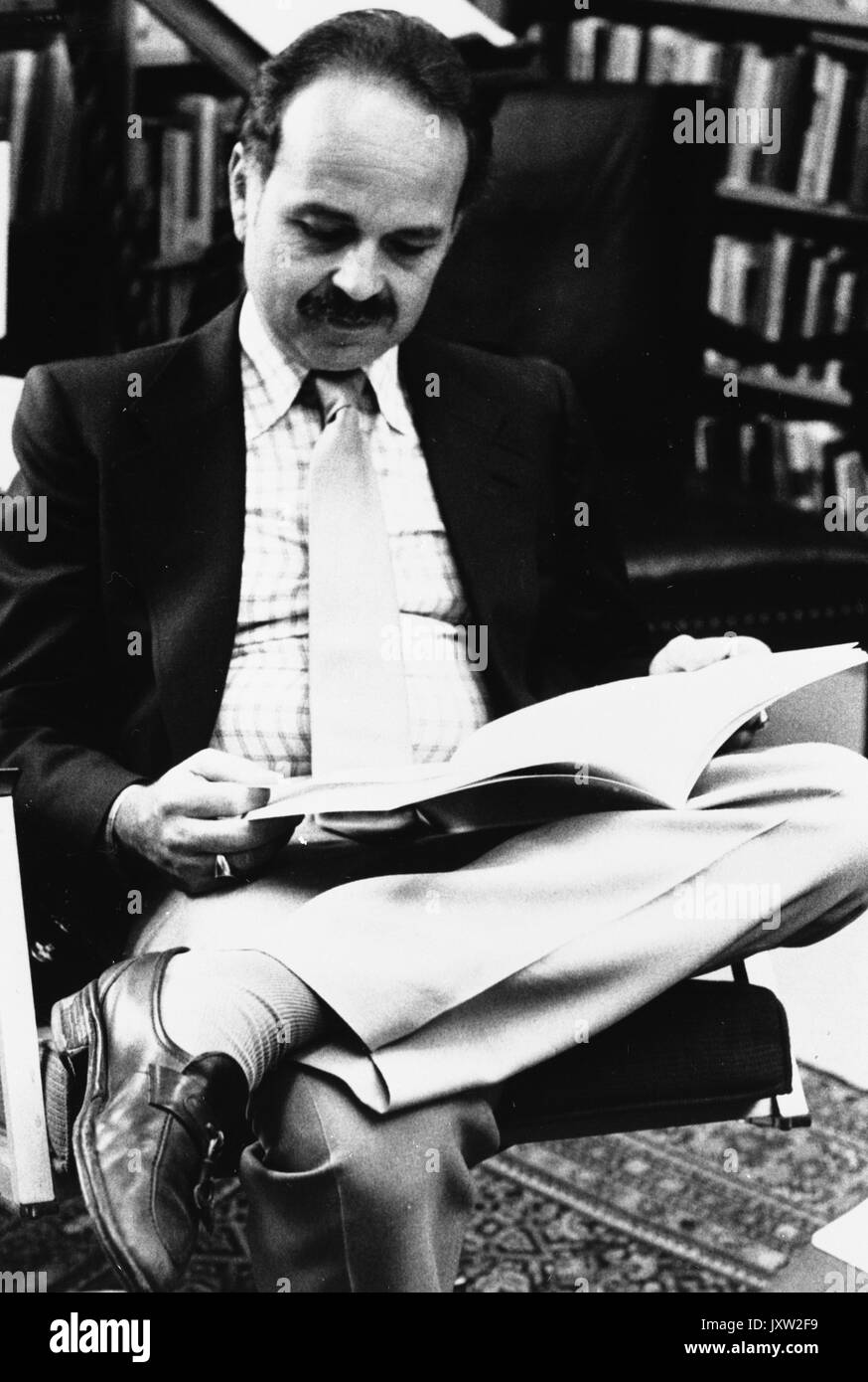 Stanley Eugene Fish, Candid photograph, Sitting in office reading, 1984 ...