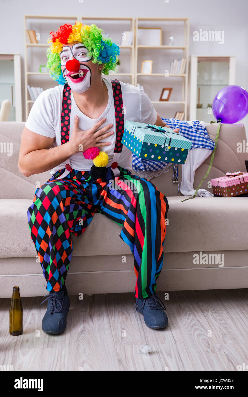 Drunk clown celebrating having a party at home Stock Photo - Alamy