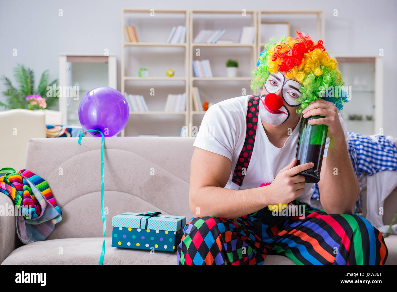 Drunk clown celebrating having a party at home Stock Photo - Alamy