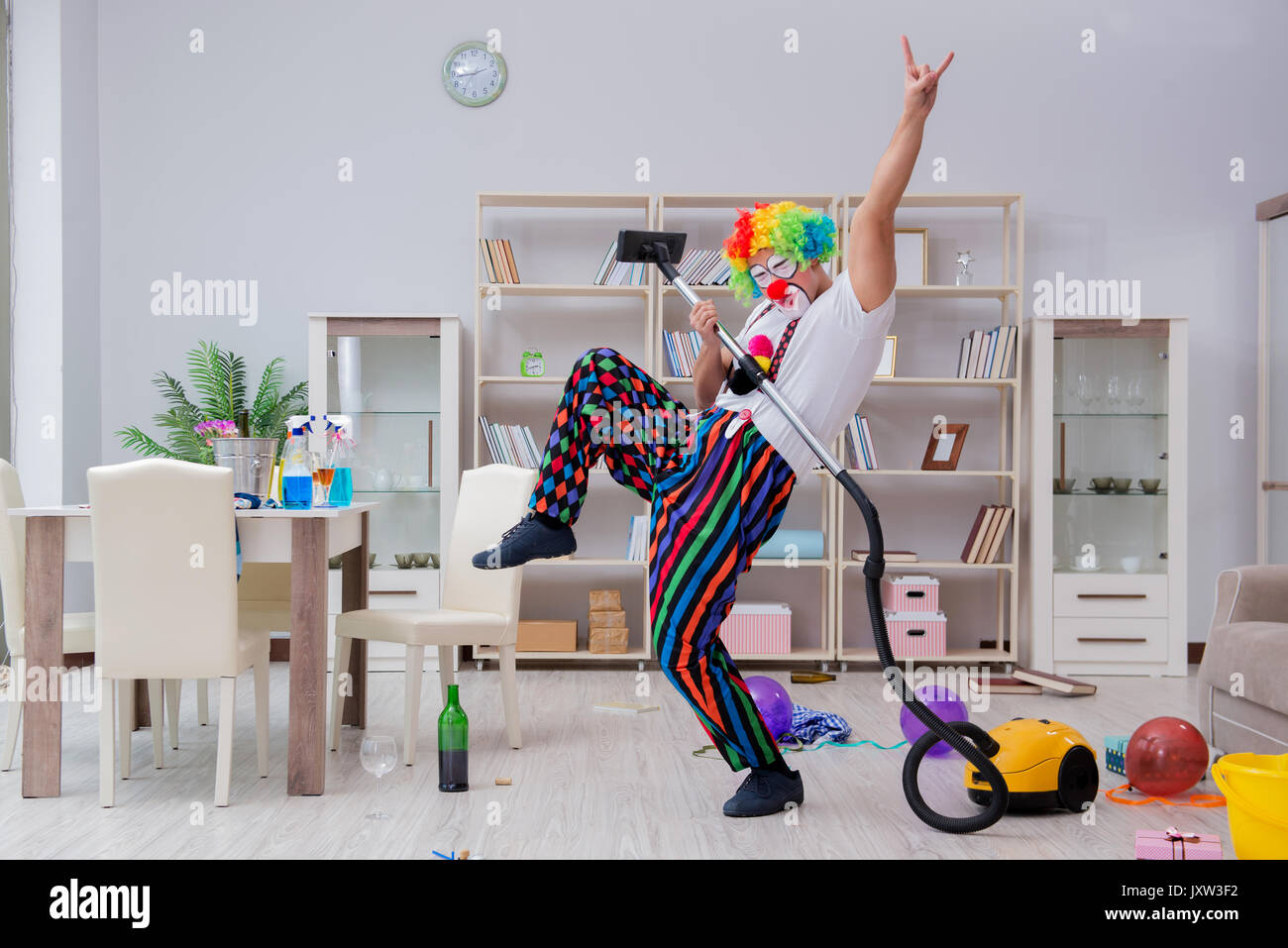 Funny clown doing cleaning at home Stock Photo - Alamy