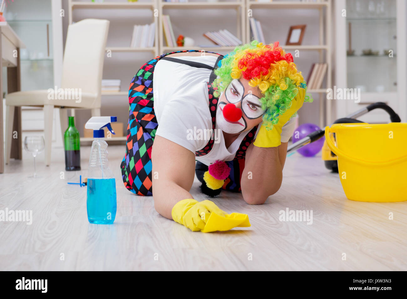 Funny clown doing cleaning at home Stock Photo - Alamy