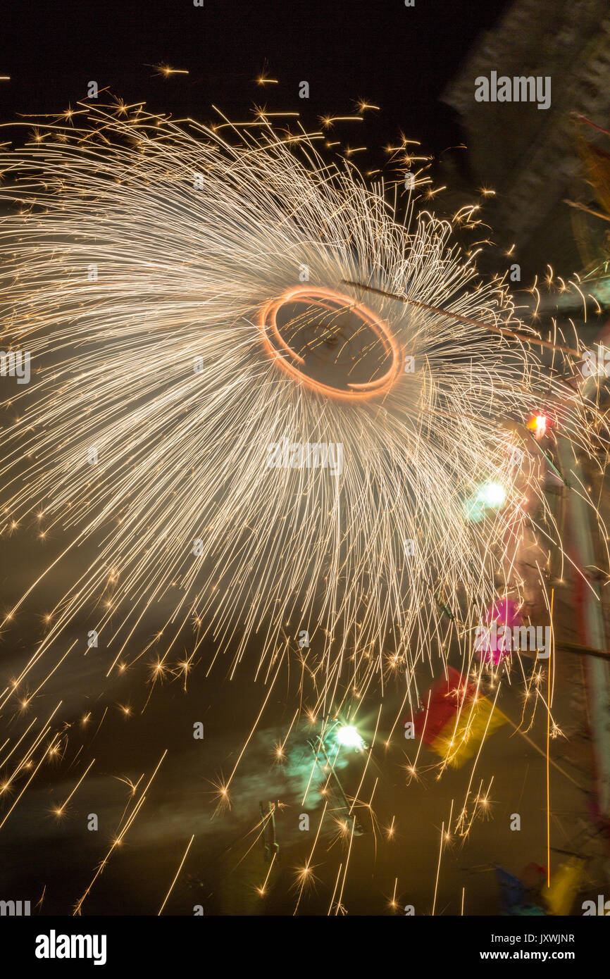 Bamboo towers are filled with various fireworks, and then lit within a ...