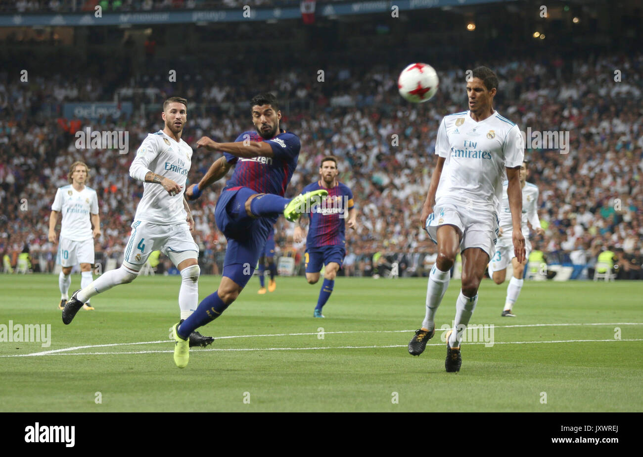 Luis Suarez shoots on goal between Sergio Ramos and Varane. Real Madrid ...