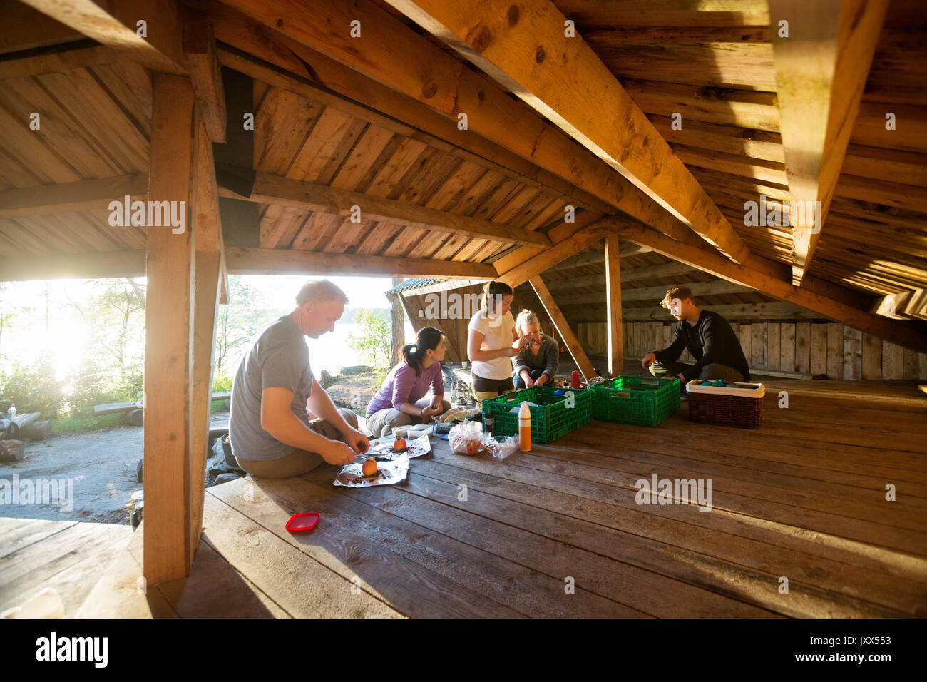 Business People Preparing Food In Shed At Forest Stock Photo - Alamy