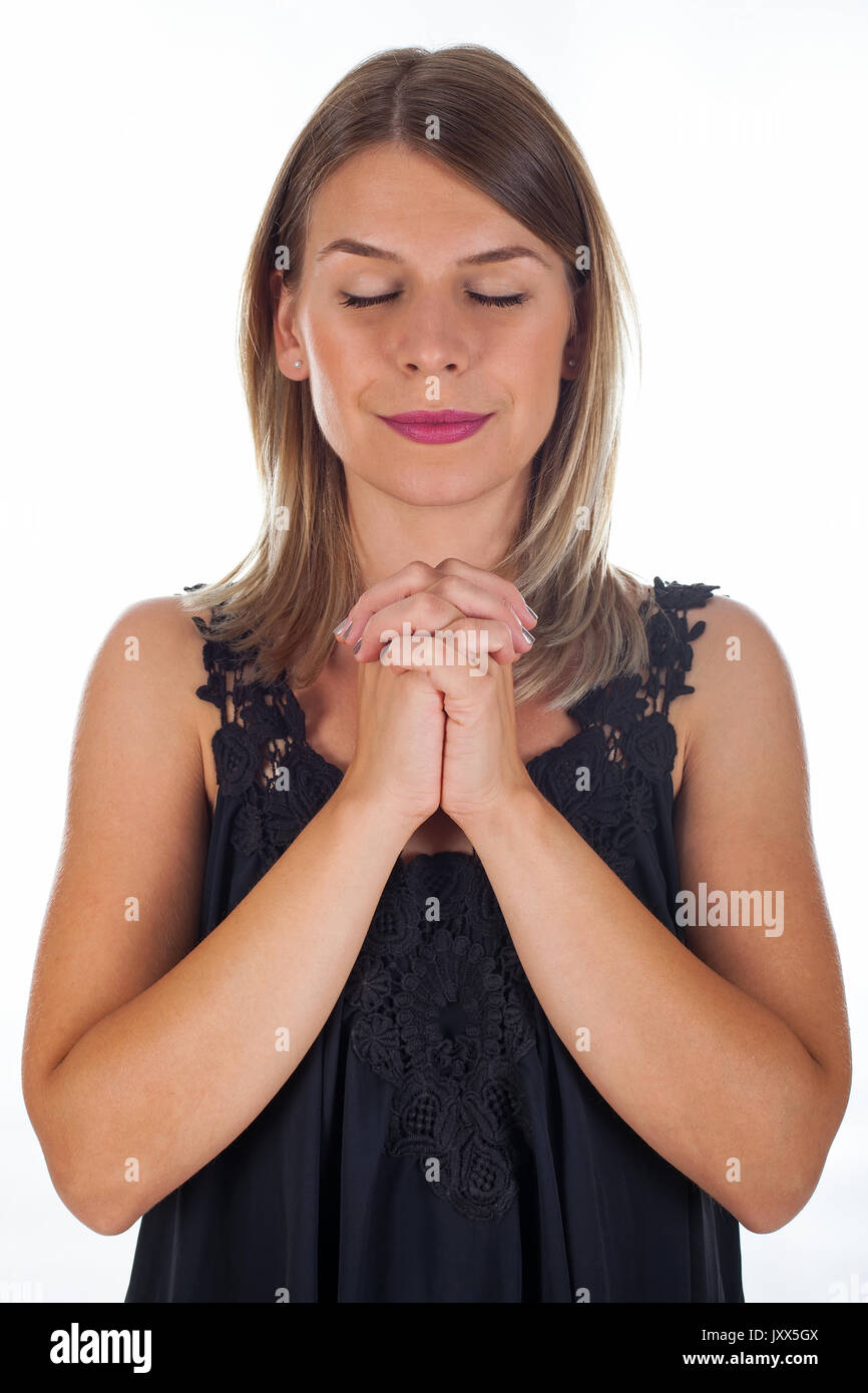 Picture of a religious young woman praying on isolated background Stock ...