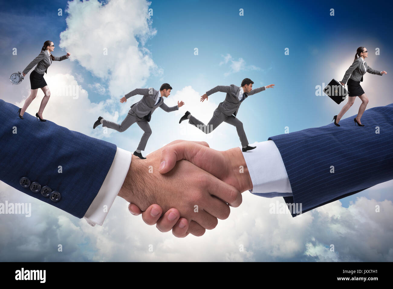 Cooperation concept with people running on handshake Stock Photo - Alamy