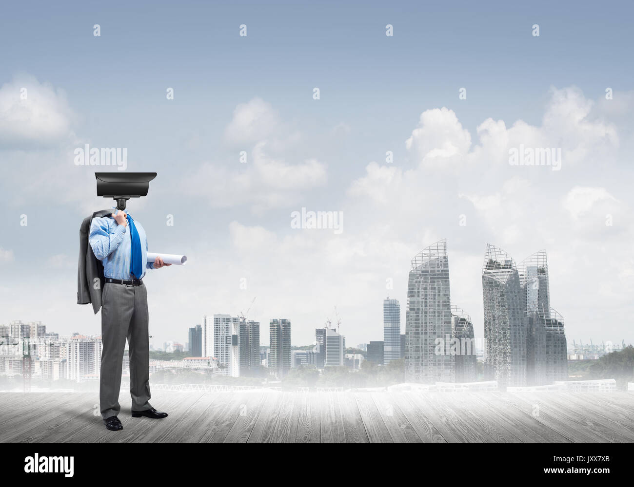 Camera headed man standing on wooden floor against modern cityscape ...
