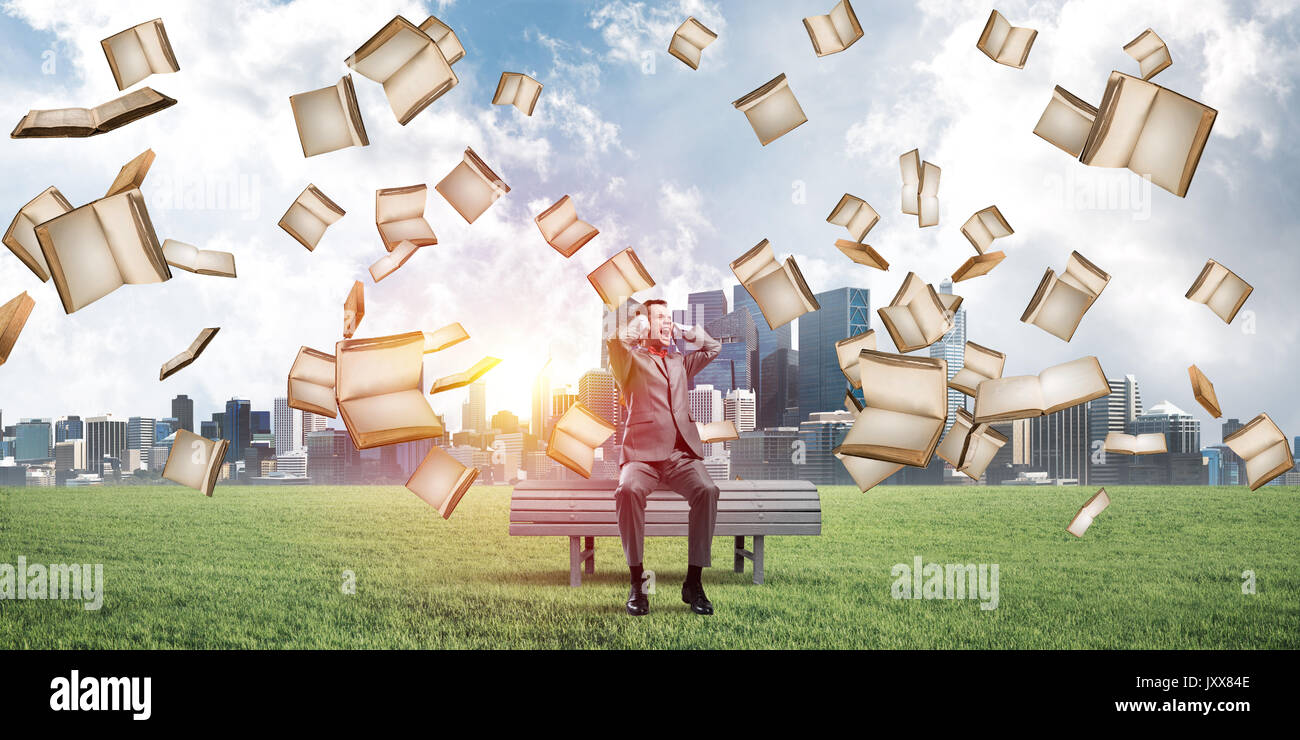 Many old books falling from above and student guy sitting on bench ...