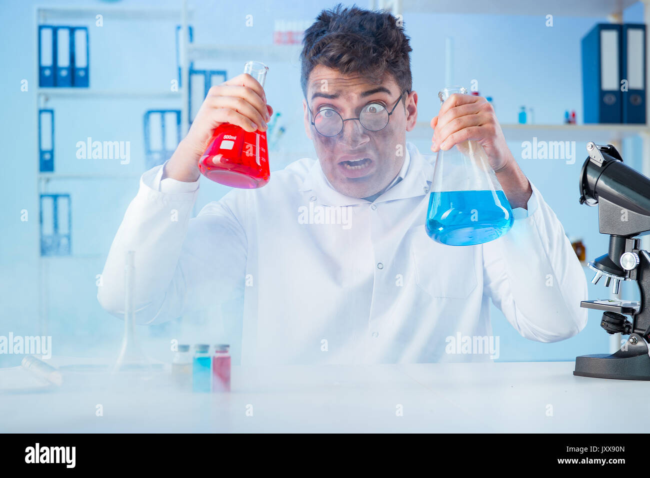 Funny mad chemist working in a laboratory Stock Photo - Alamy