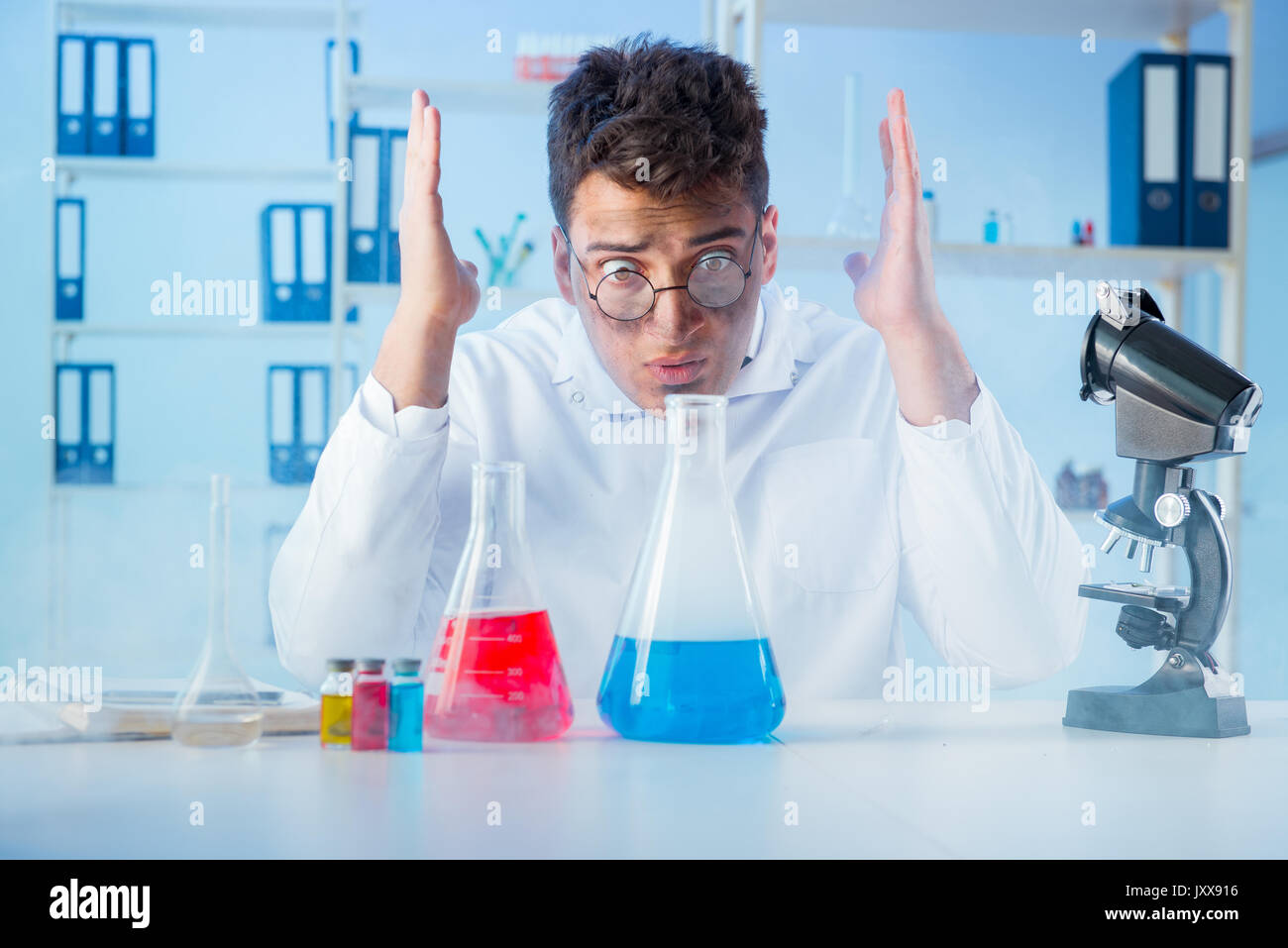 Funny mad chemist working in a laboratory Stock Photo - Alamy