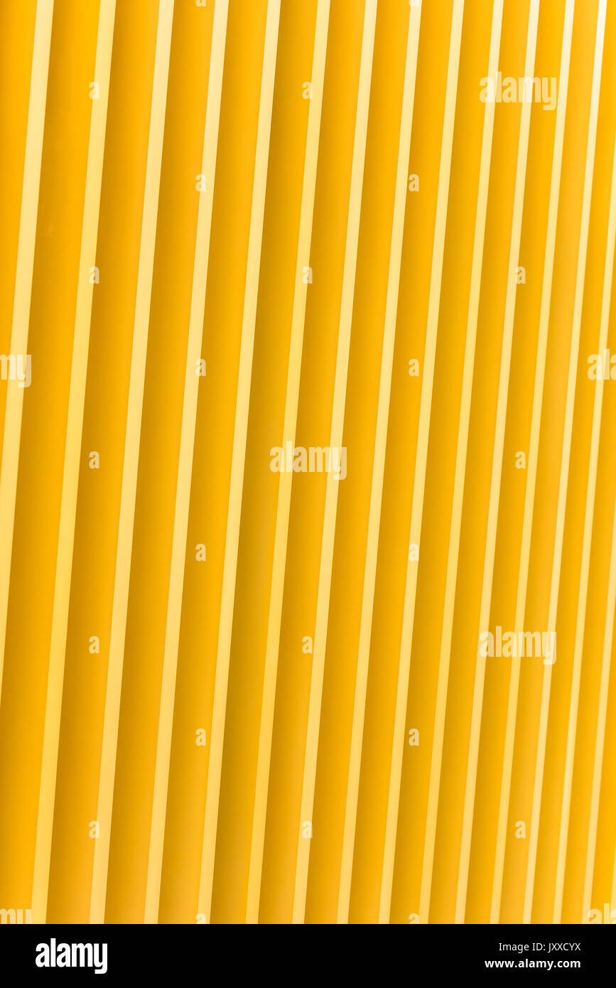 Detail of bright yellow metal building facade. For background Stock ...