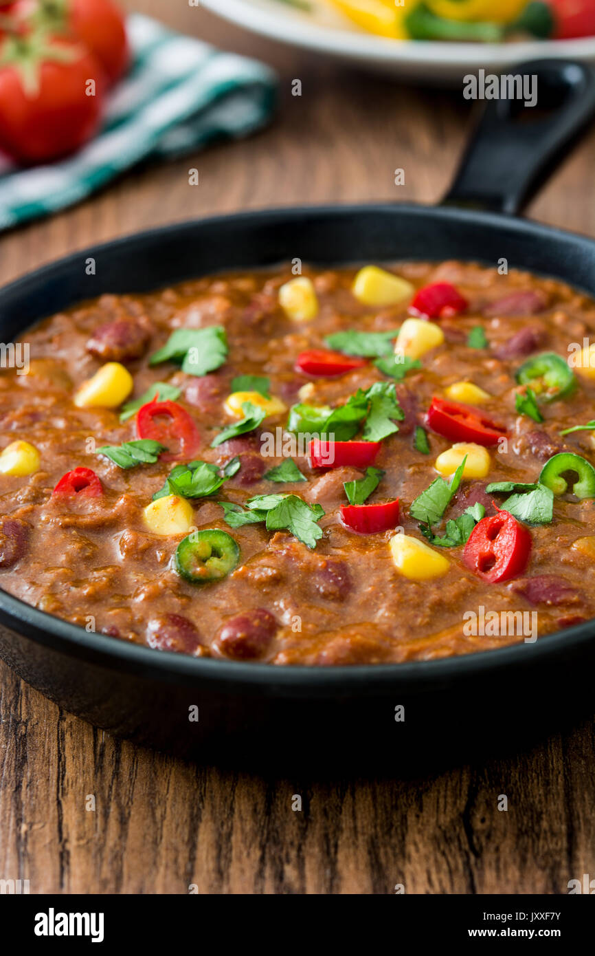 Traditional mexican tex mex chili con carne in a frying pan on wooden ...