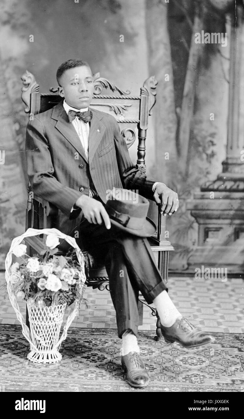 Man sitting on chair full Black and White Stock Photos & Images - Alamy