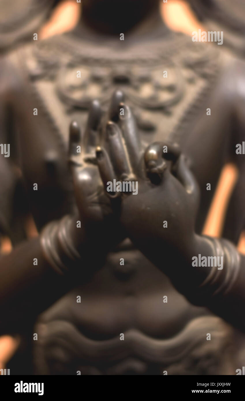 blurred background of staute's hand making gesture which stand for ...