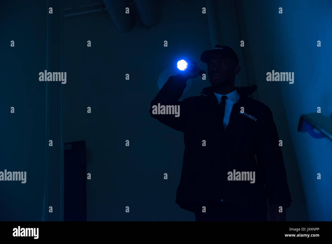 Male Security Guard In Black Uniform Holding Flashlight Stock Photo - Alamy