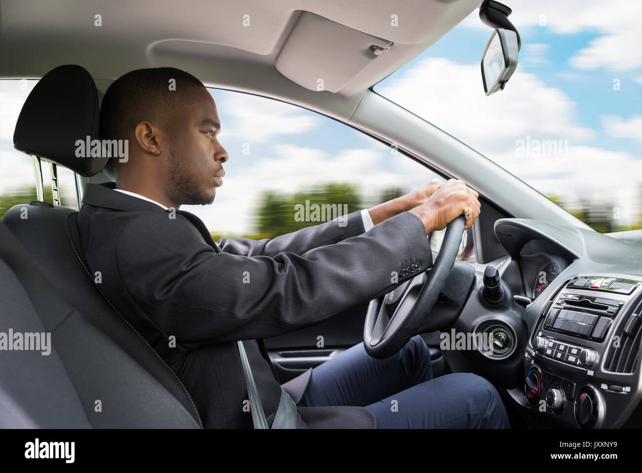Side View Of A Young Businessman Driving Car Stock Photo - Alamy