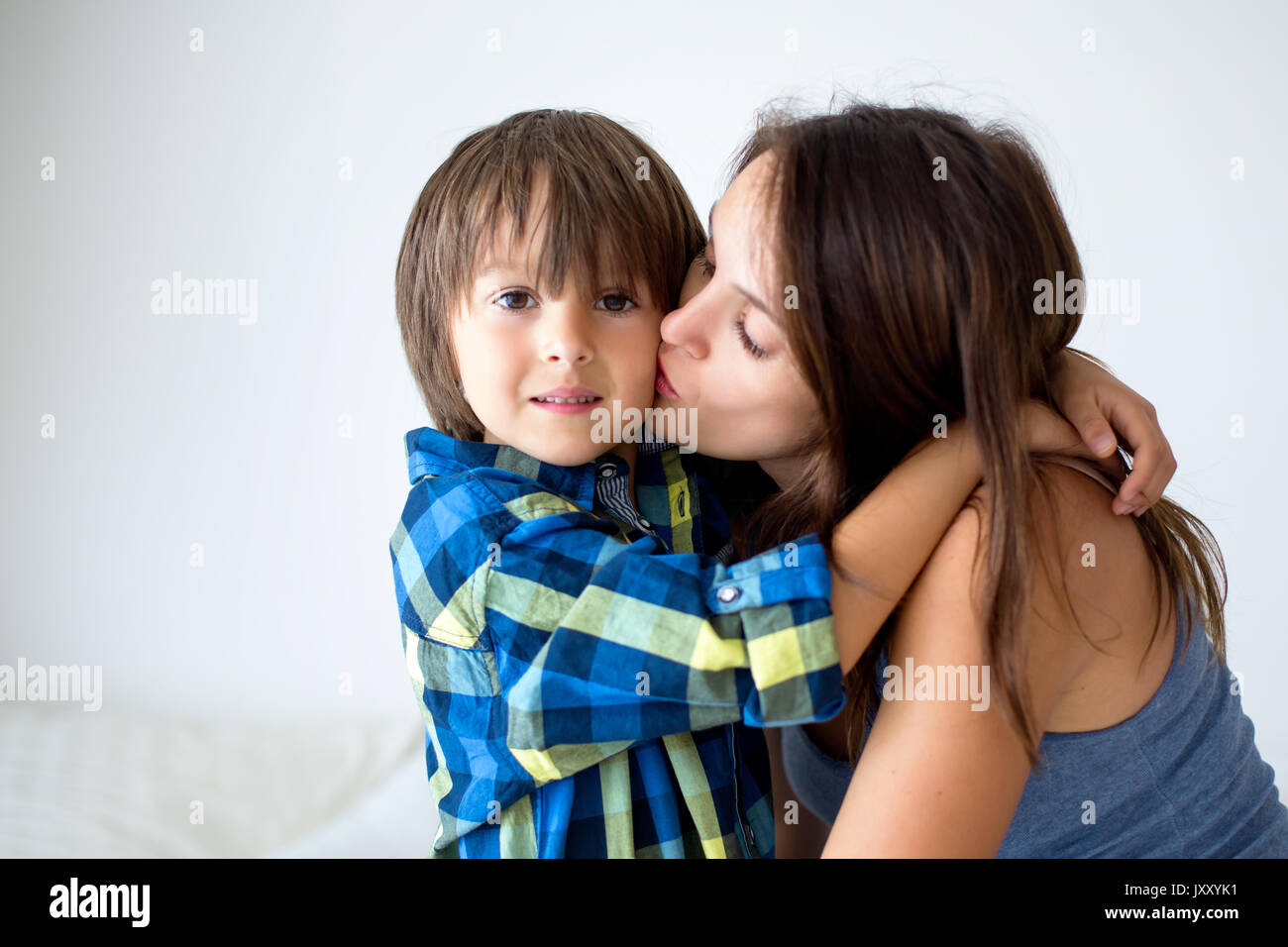 Portrait of beautiful pregnant mother, hugging with love and tenderness ...
