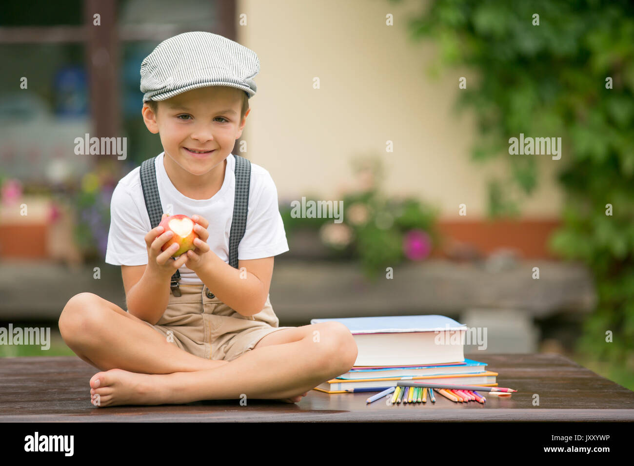 Boy, writing his homework from school, drawing and writing in his ...