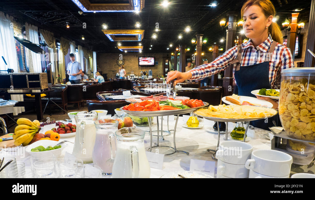 waiter serves a buffet with a variety of breakfast snacks Stock Photo ...