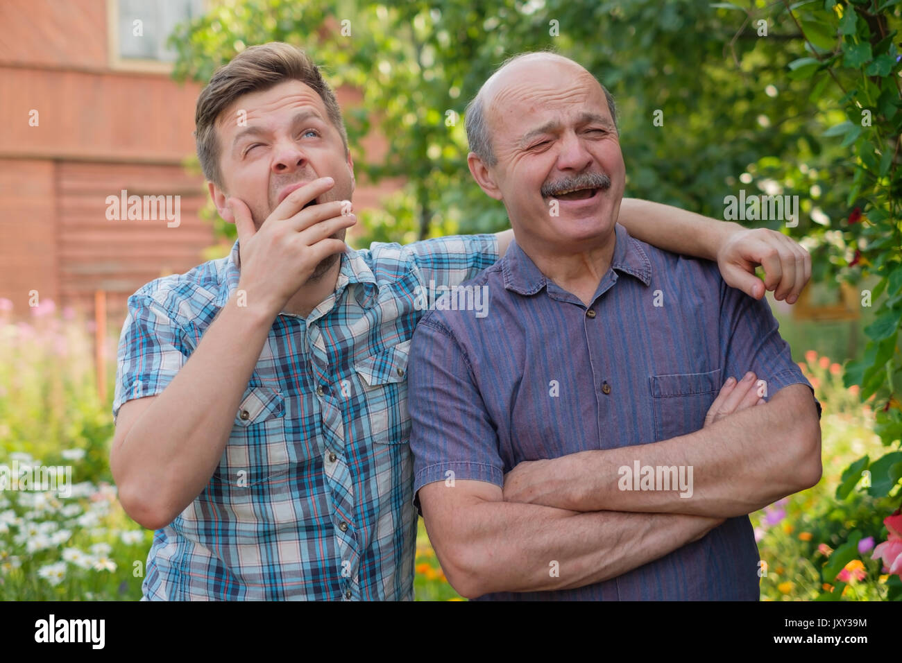 two yawning tired men at county side at sunny day Stock Photo - Alamy