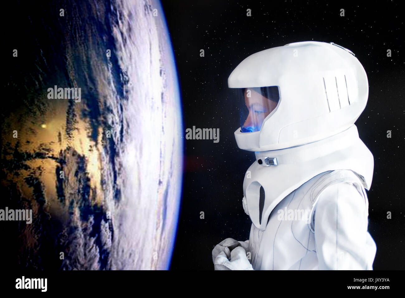 Astronaut looking at Earth from space. Elements of this image furnished ...
