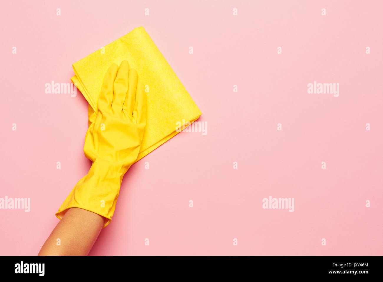 The woman's hand cleaning on a pink background. Cleaning or ...