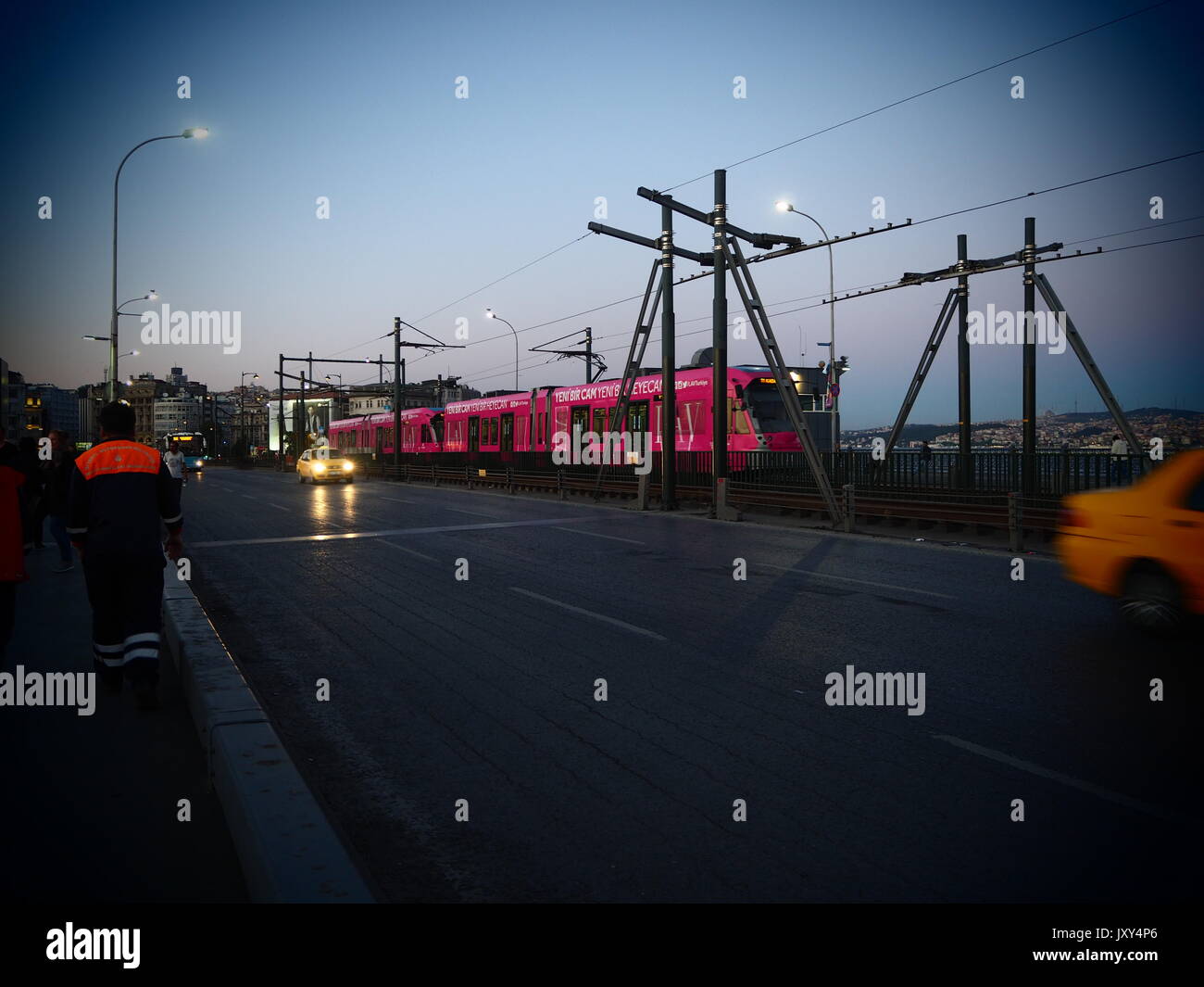 Pink color Tram in Istanbul is running on the bridge Stock Photo - Alamy