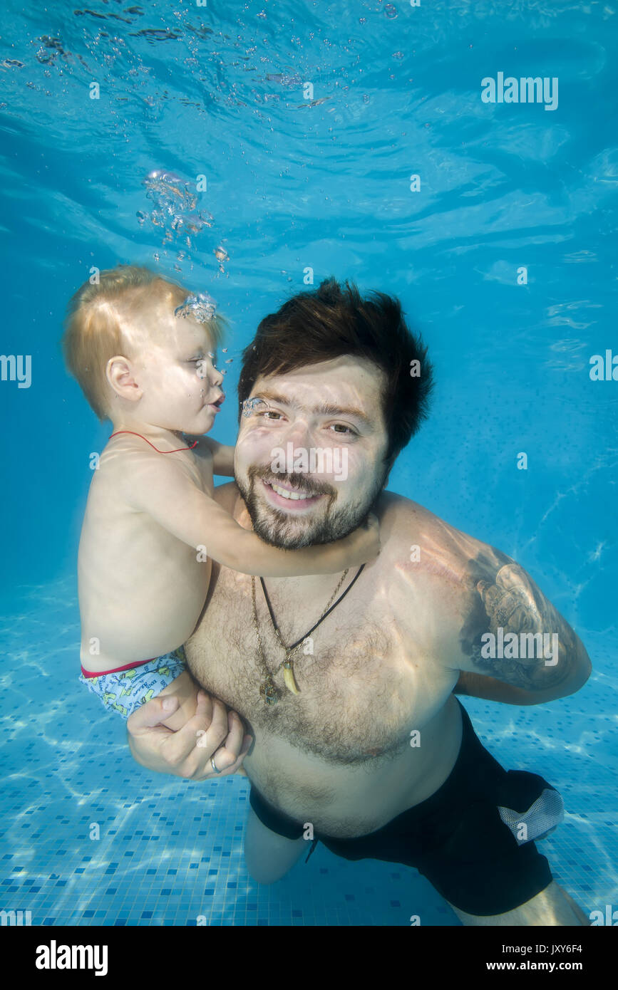 Dad and son swimming underwater hi-res stock photography and images - Alamy