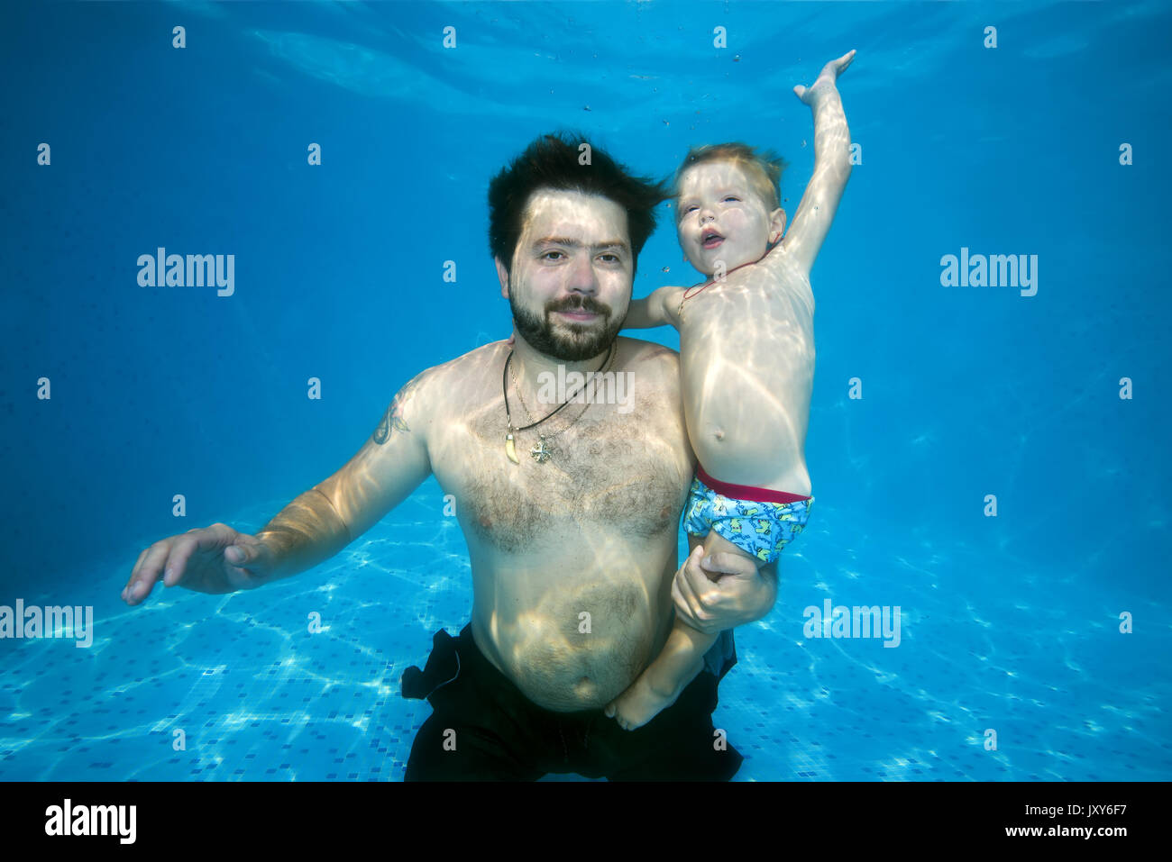 Dad and son swimming underwater hi-res stock photography and images - Alamy