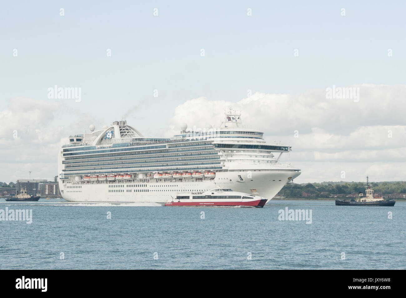 Crown Princess at the Port of Southampton being turned by two tugs ...