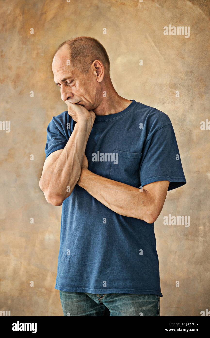 Worried mature man touching his head Stock Photo - Alamy