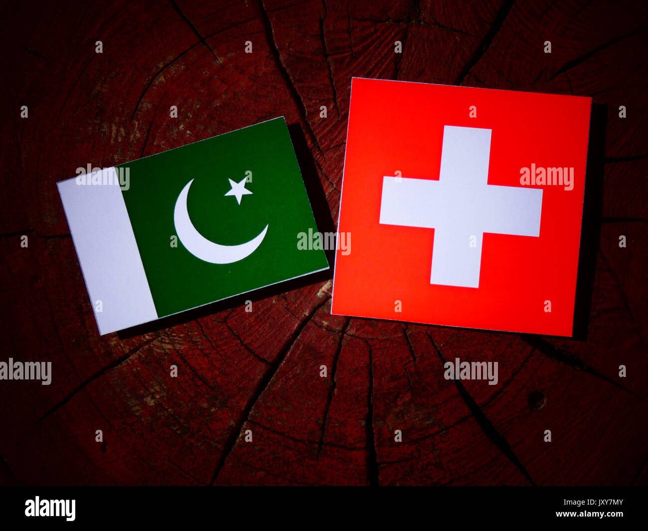 Pakistan flag with Swiss flag on a tree stump isolated Stock Photo - Alamy