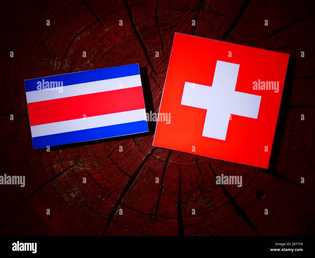 Costa Rican flag with Swiss flag on a tree stump isolated Stock Photo ...