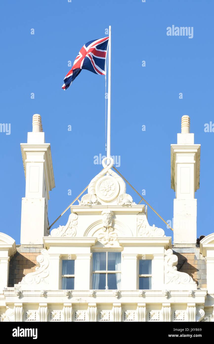 Seaside building with flag waving Stock Photo - Alamy