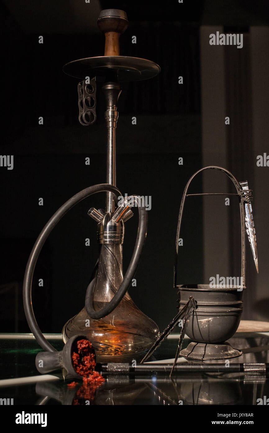 Orange shisha with all accessories placed on the table in hookah bar ...