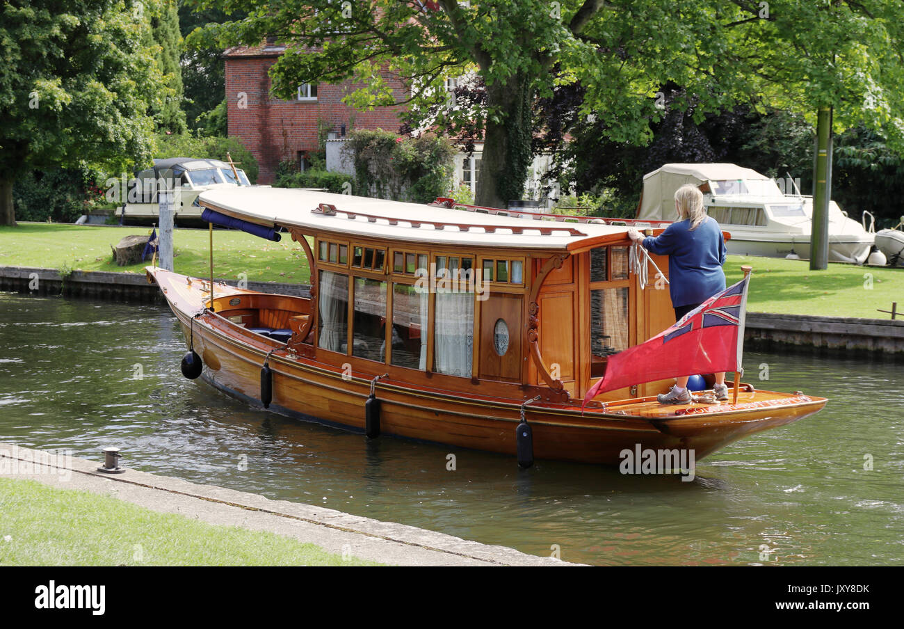 Elegant wooden boat approaching Hurley Lock on the river Thames in ...