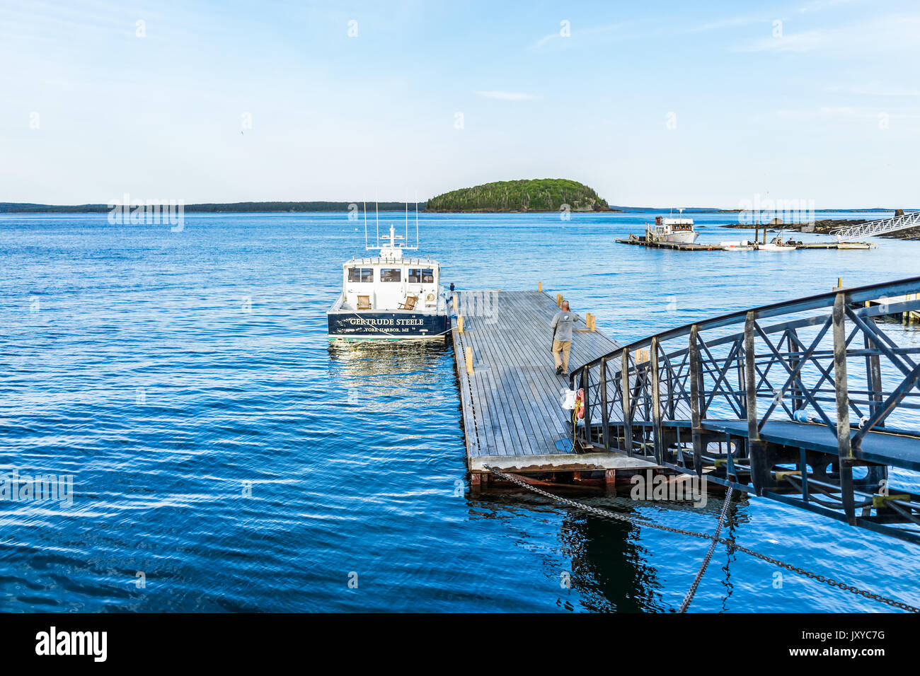 Bar Harbor, USA - June 8, 2017: View of dock and boat with man in ...