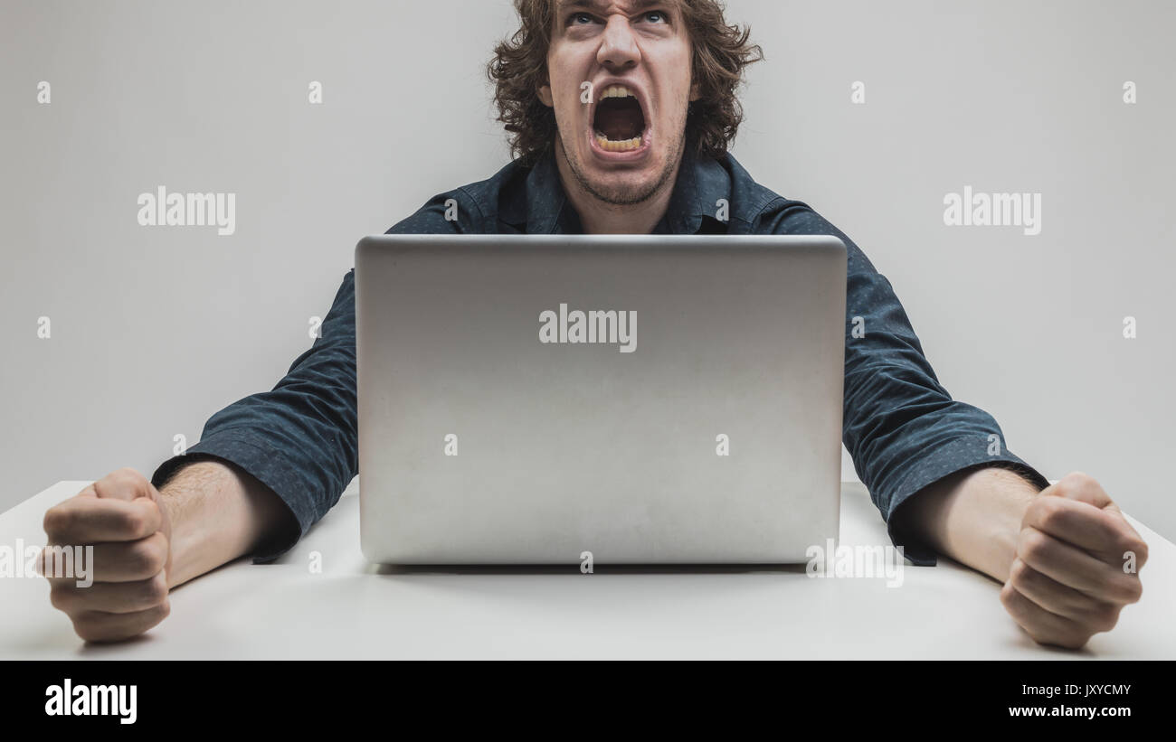 angry man swearing and cursing against information technology and his ...