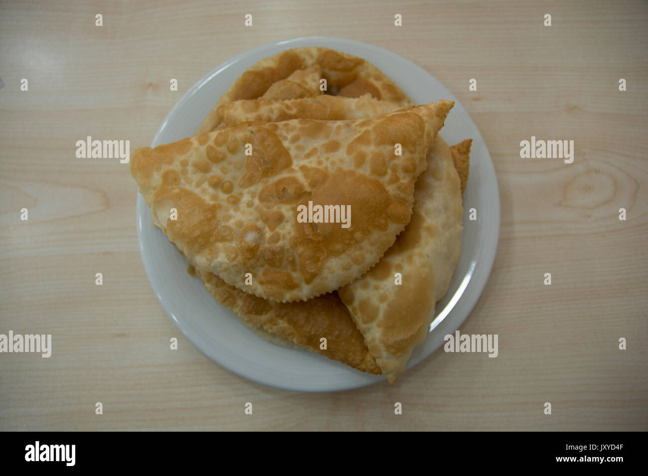 A mixture of minced meat, onion and spice is put in the opened yufkay ...