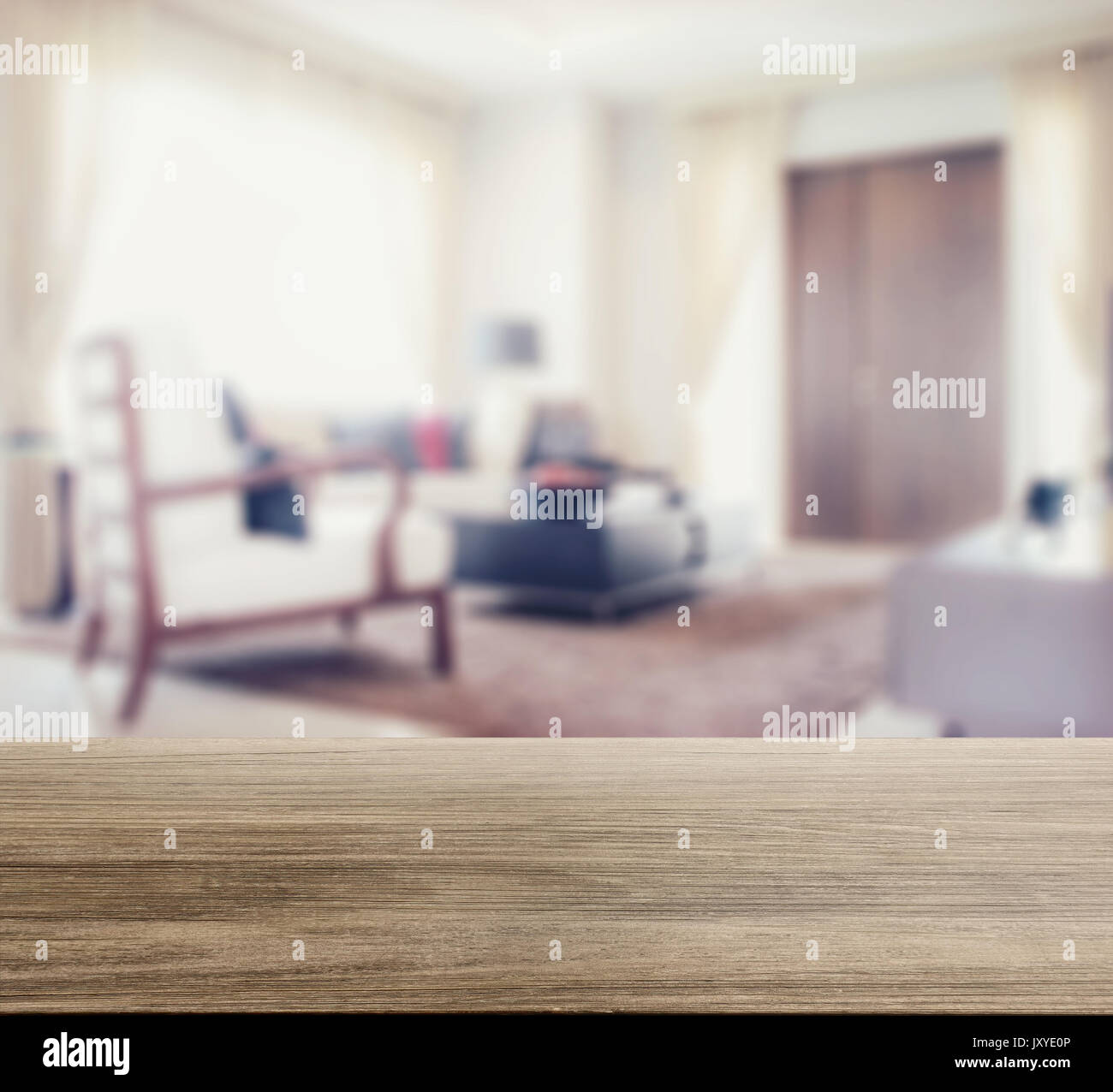 wooden table top with blur of modern living room interior Stock Photo ...