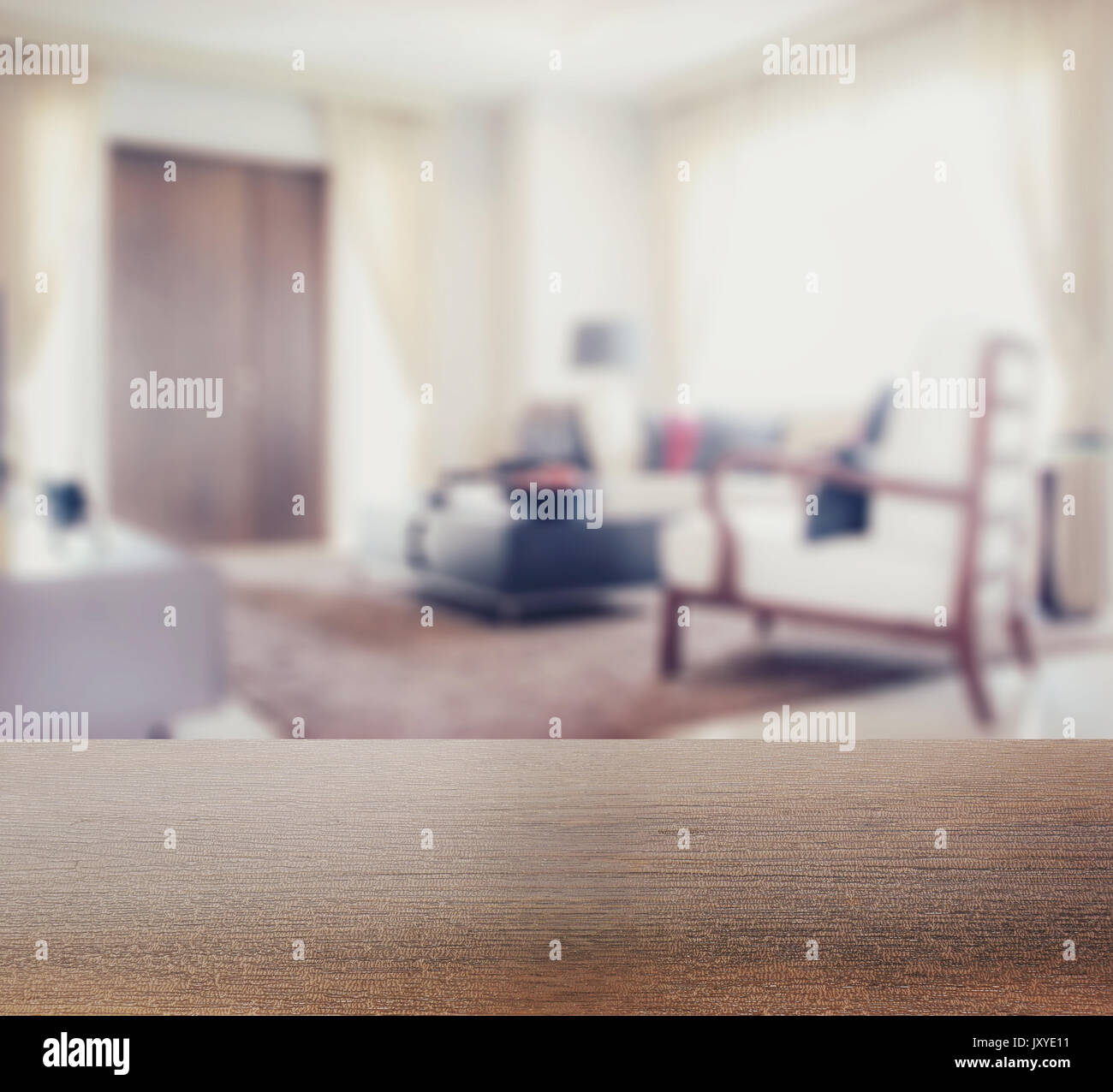wooden table top with blur of modern living room interior as background ...