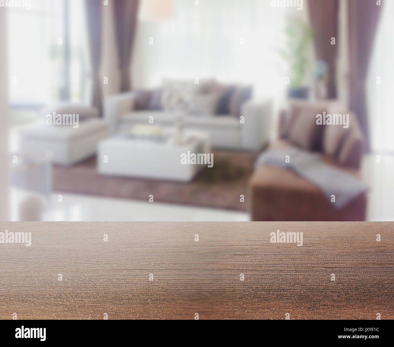 wooden table top with blur of modern living room interior as background ...