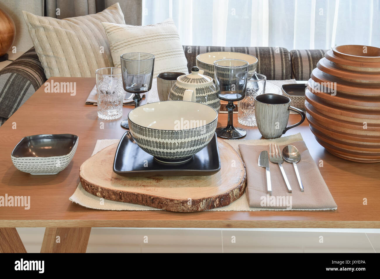 elegant table set in modern style dining room interior Stock Photo - Alamy