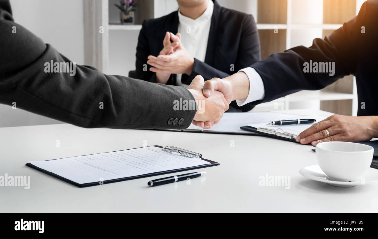 successful business team shaking hands with eachother in the office ...